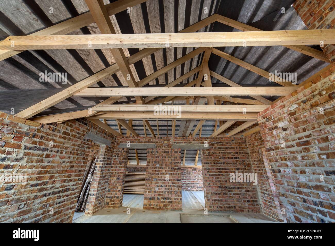 Attic of a building under construction with wooden beams of a roof ...