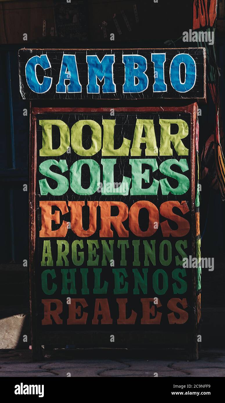 A colorful advertisement board displaying the differents currency ...