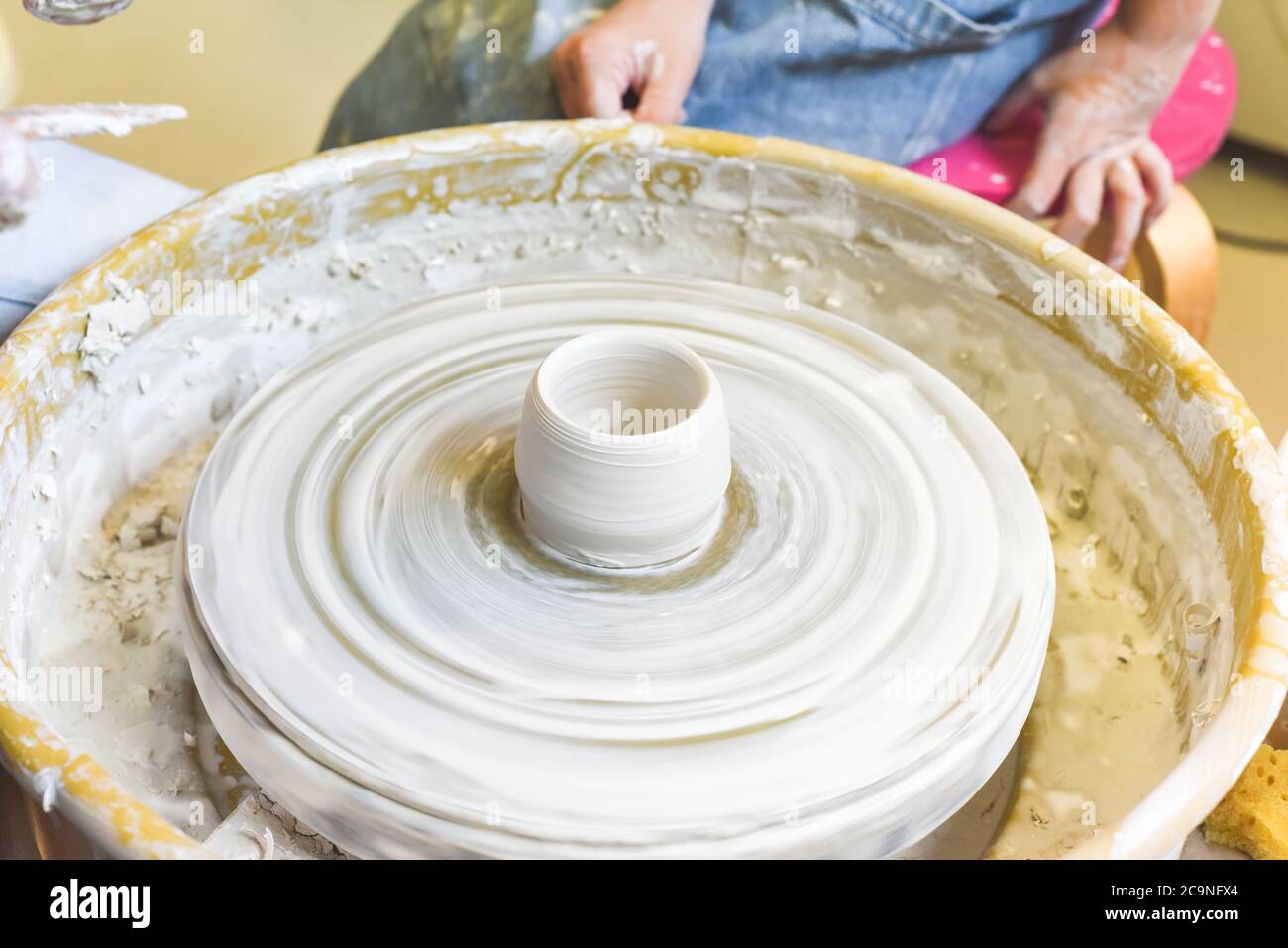 Children learning to make pottery as a hobby with their grandmother in ...