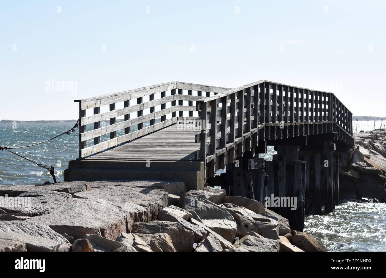 Wood bridge and jetty creating a sea wall Stock Photo - Alamy