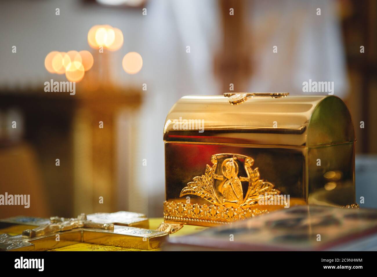 Christening in the church, golden religious utensils: bible, cross ...