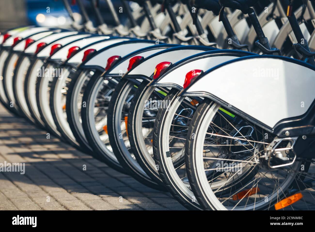 Wheels of bicycles at rental station Stock Photo - Alamy