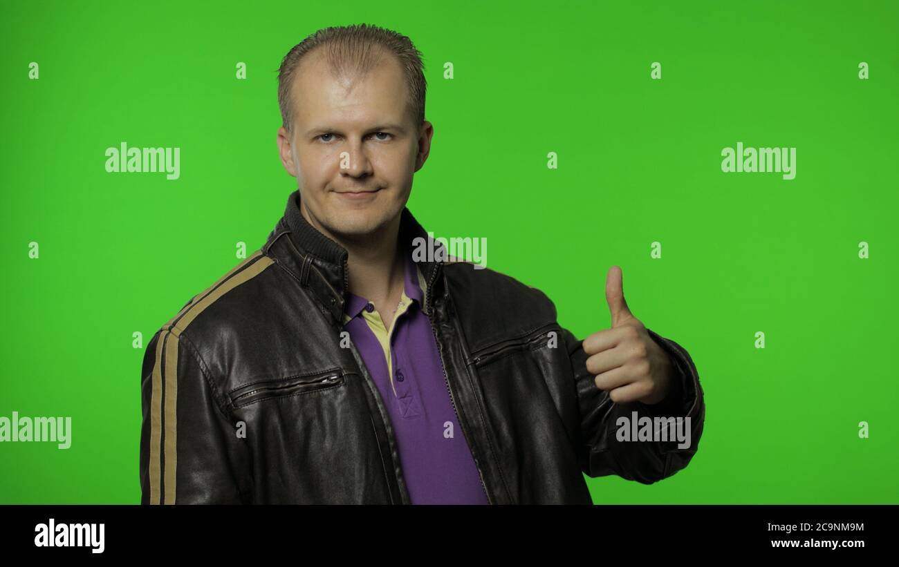 Cheerful rocker man showing double thumbs up and smiling, laughing ...