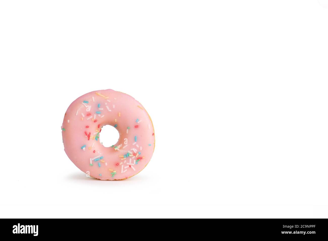 fresh pink donut with sprinkles isolated on white background with soft ...