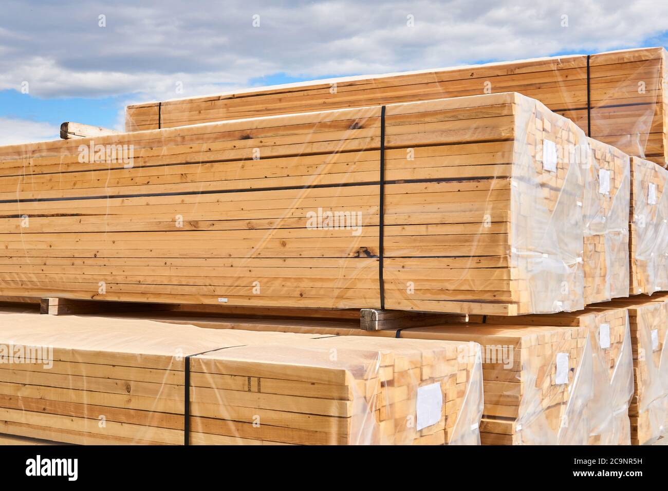 packs of new wooden planks packed for loading and transportation ...