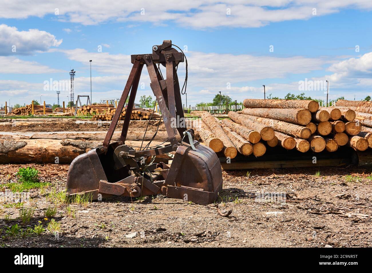 old rusty grapple bucket of the excavator in the yard of a woodworking ...