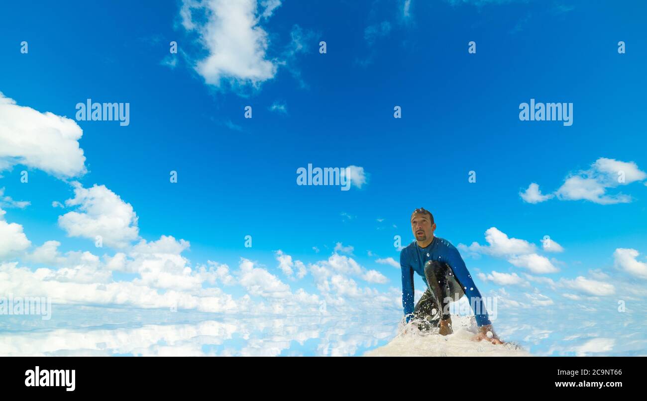 Green wave blue sky surfer hi-res stock photography and images - Alamy