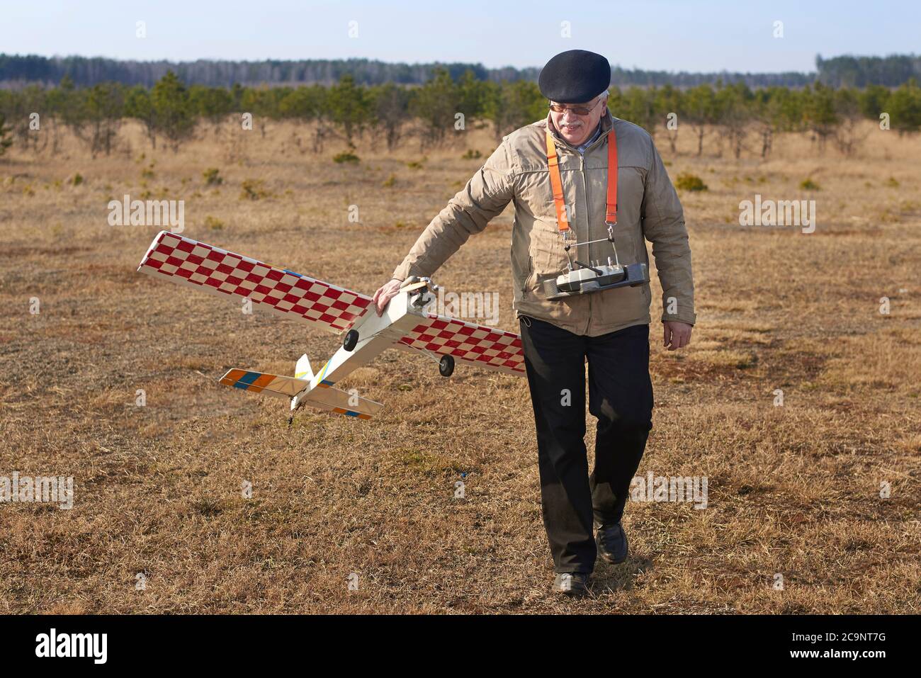 Elderly man holds RC airplane with a broken propeller after the crash ...