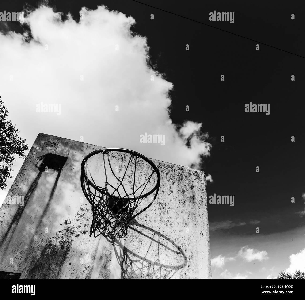 Old basketball hoop on a residential back yard in black and white ...