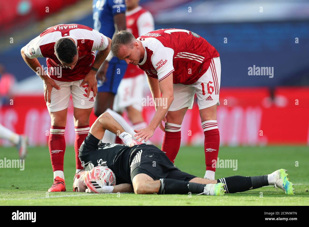 Arsenal goalkeeper Emiliano Martinez lies injured on the pitch during ...