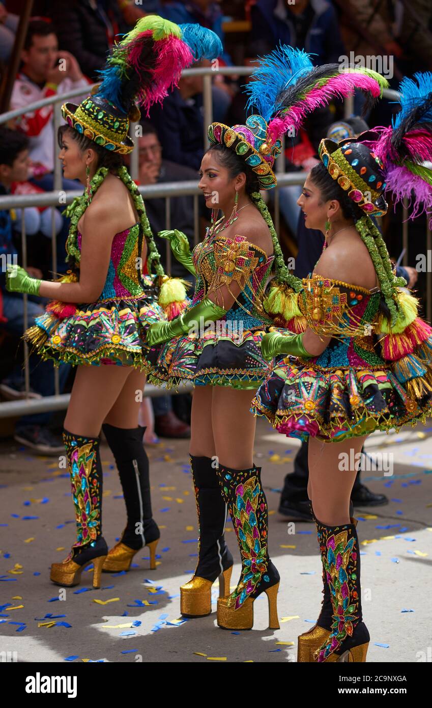 Morenada dancers in ornate costumes parade through the mining city of ...