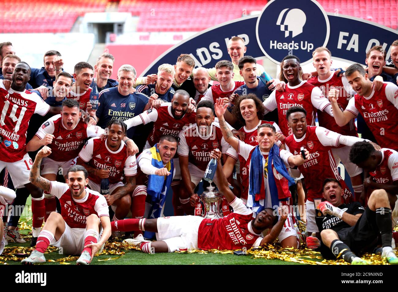 Arsenal players and staff celebrate with the trophy after winning the ...