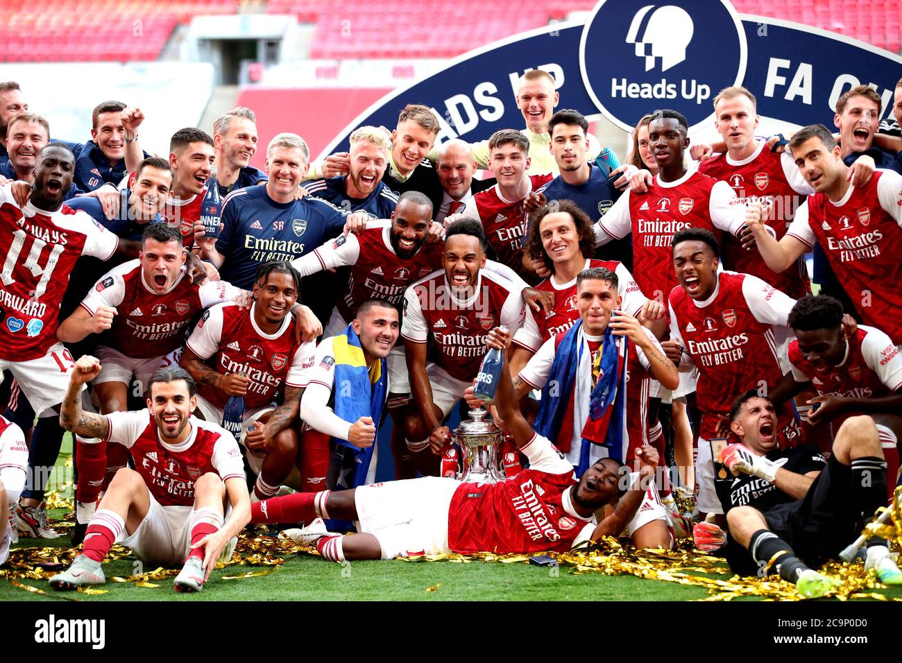 Arsenal players and staff celebrate with the trophy after winning the ...