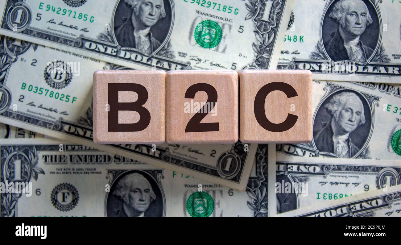 Concept word 'B2C' on cubes on a beautiful background from dollar bills ...