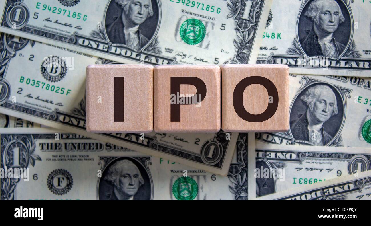 Concept word 'IPO' on cubes on a beautiful background from dollar bills ...