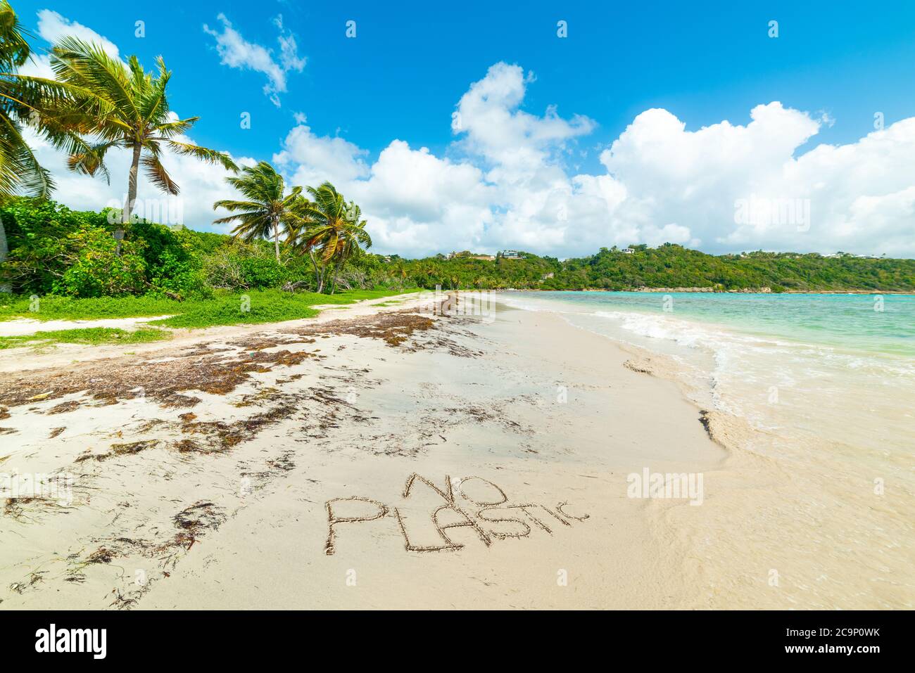 No Plastic written on white sand in a beautiful tropical beach in the ...