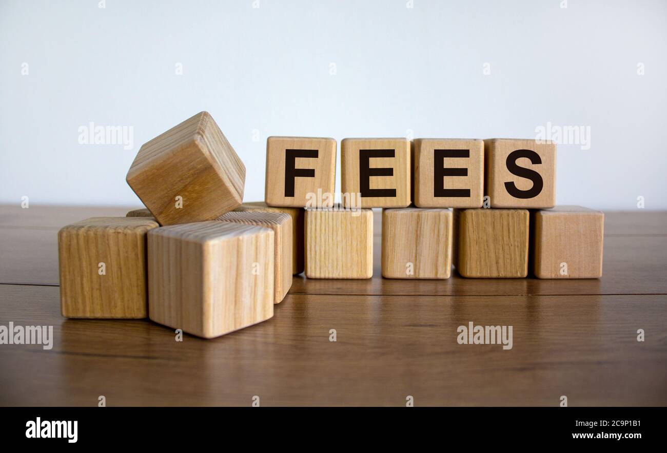 Concept word 'fees' on cubes on a beautiful wooden table. White ...