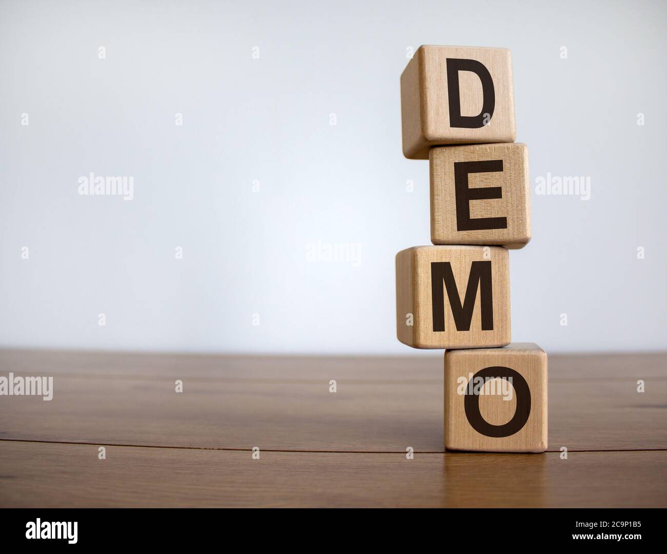 Concept word 'demo' on cubes on a beautiful wooden table. White ...