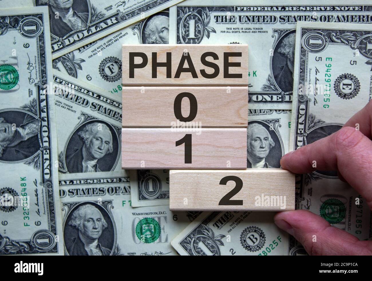 Wooden blocks form the words 'phase, 0, 1, 2' on background from dollar ...