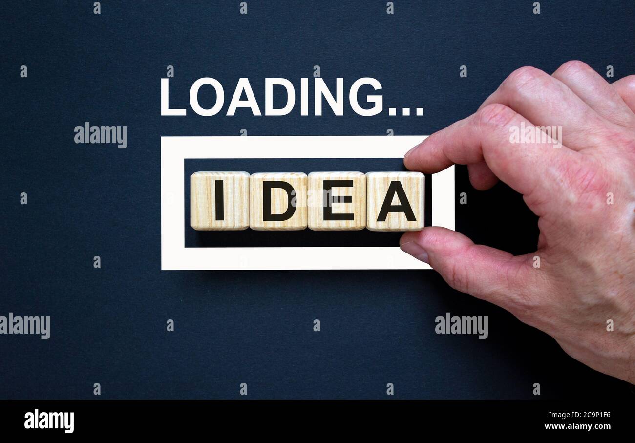 Loading word &#039;idea&#039; with hand putting wood cube in progress bar ...