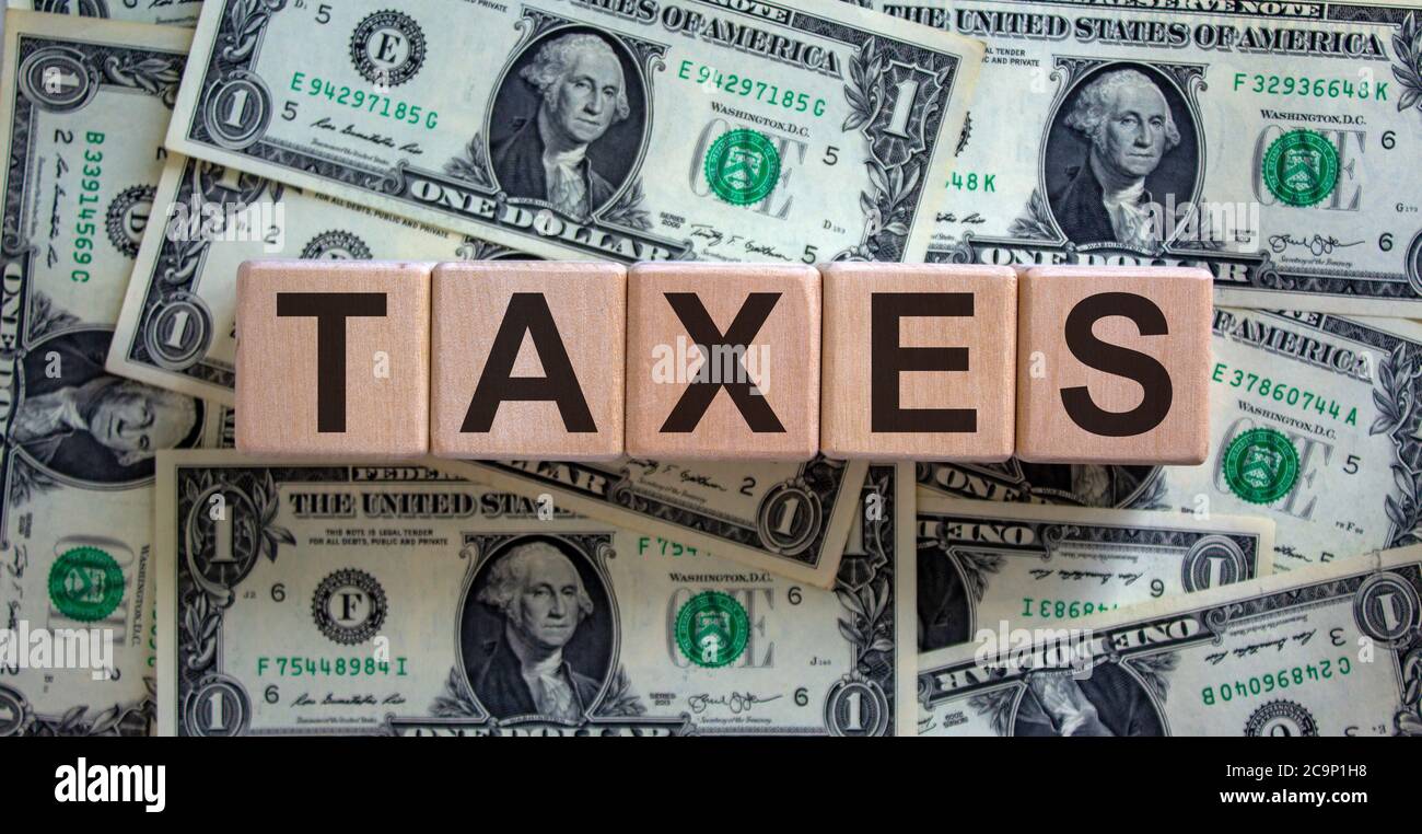 Concept word 'taxes' on cubes on a beautiful background from dollar ...