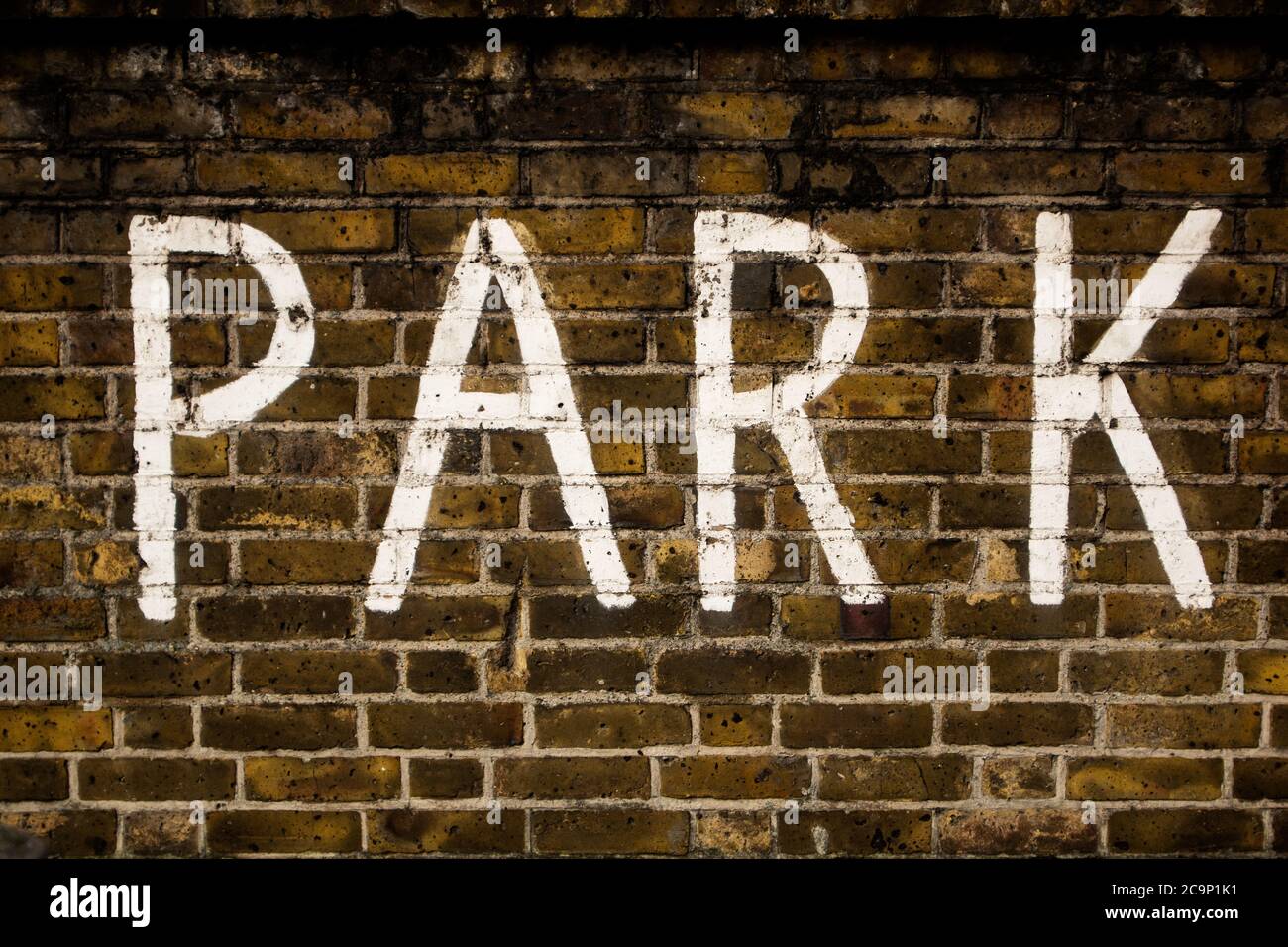 Old brick wall with the word PARK written on it Stock Photo - Alamy