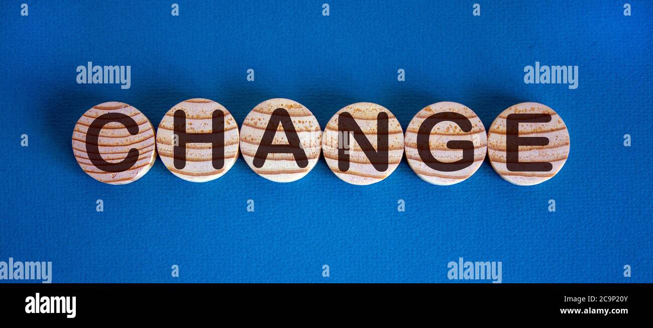 The word 'change' on wooden circles on blue table. Beautiful background ...