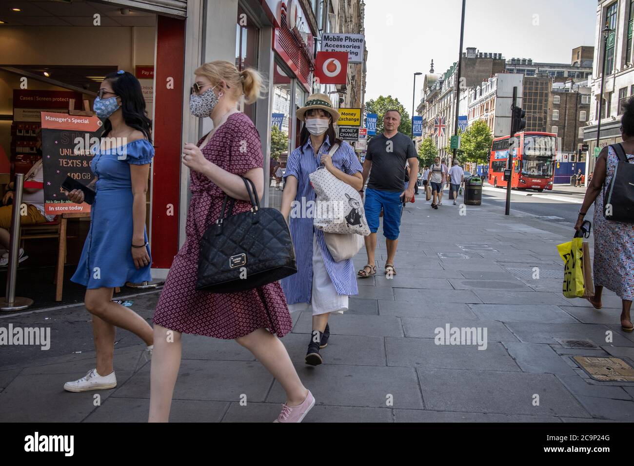 People wearing face masks return to high streets across Soho and the ...