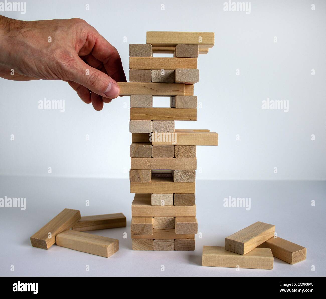 Wood block tower with architecture model. Concept Risk of management ...