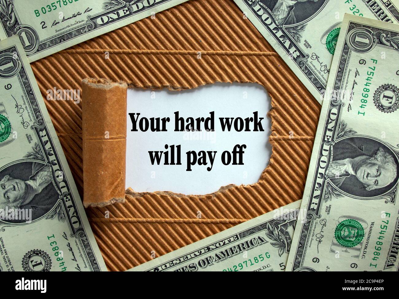 The text 'your hard work will pay off' appearing behind torn brown ...