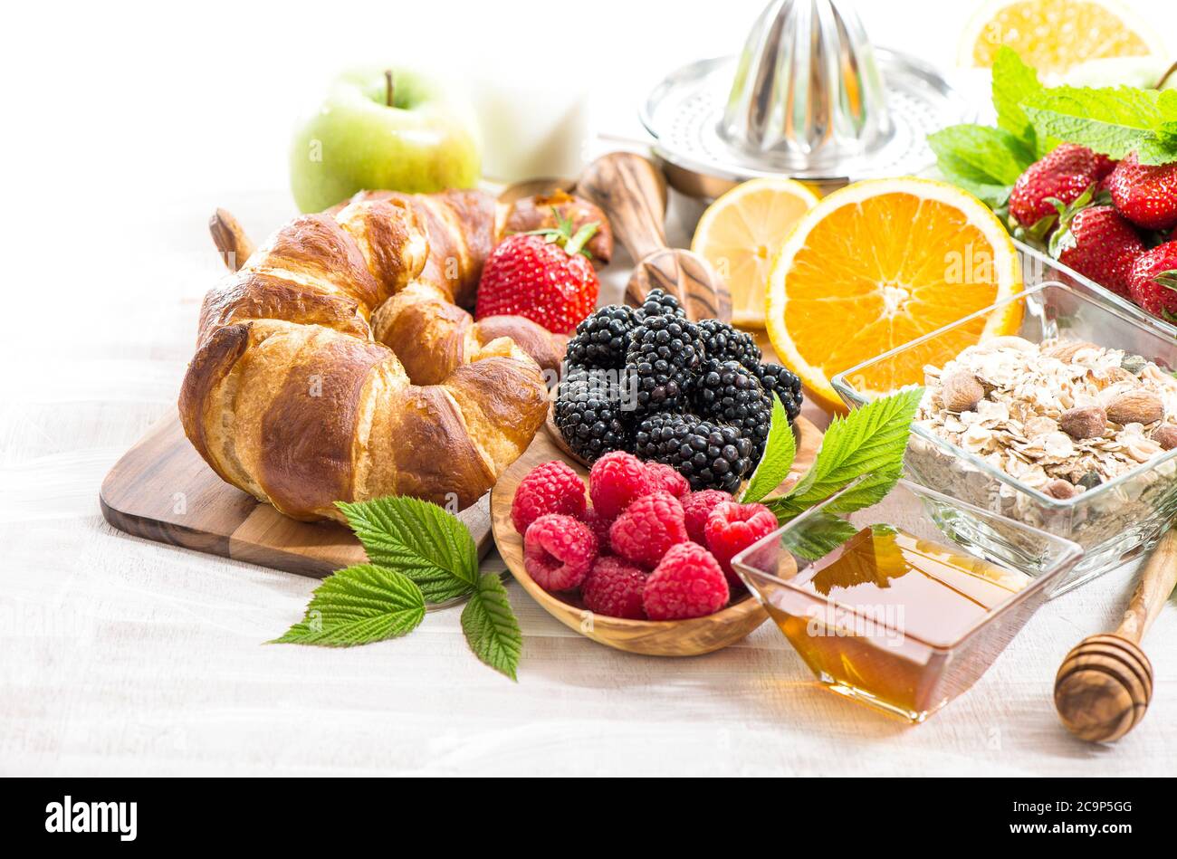 Healthy food. Breakfast table with fresh berries, fruits, honey ...