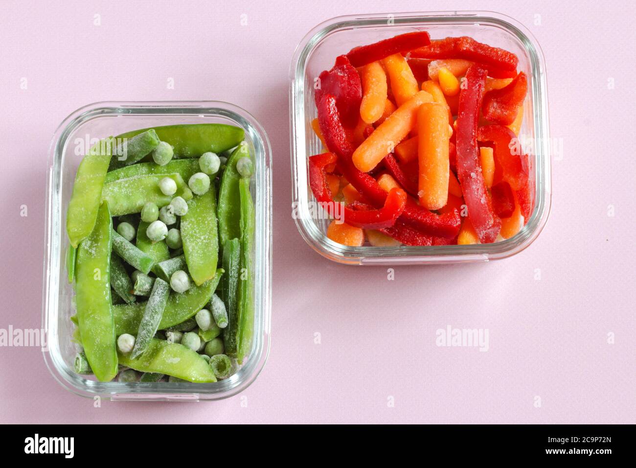 Frozen vegetables in the transparent bowls on the concrete wooden ...