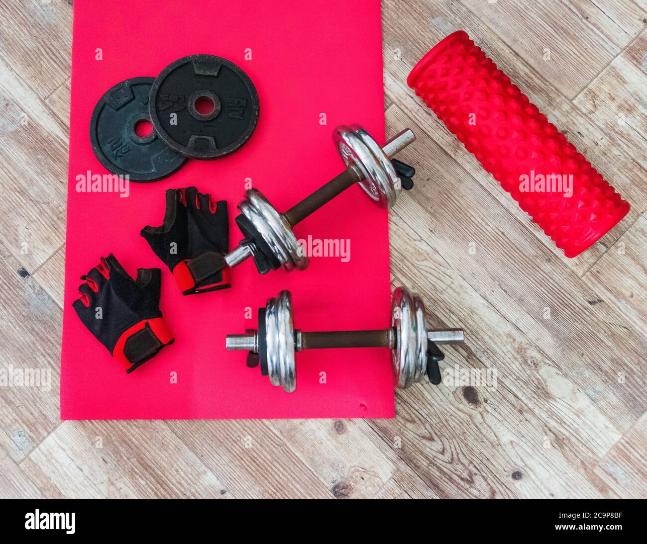 Dumbbells, foam roll and other objects for home workout seen from above ...