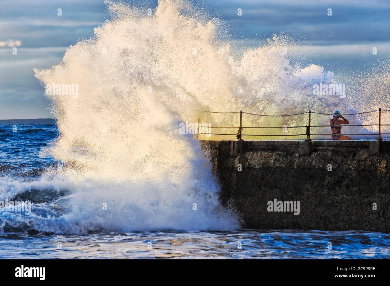 Unrecognisable swimmer at Sydney Bondi rock pool under huge wave ...