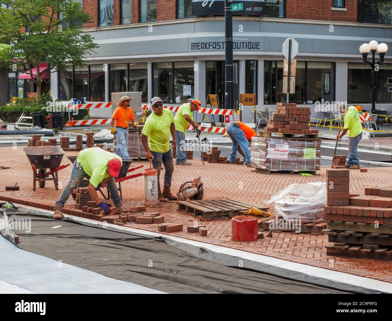 Construction workers laying brick pavement during Lake Street ...