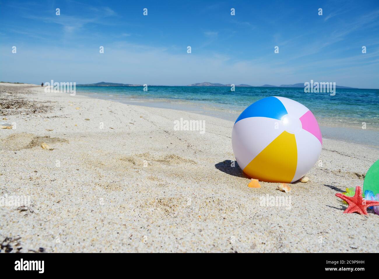 Beach ball and green rackets on the beach in summertime Stock Photo - Alamy
