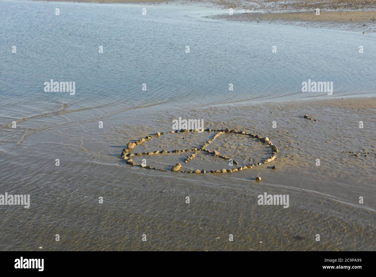 Peace sign in shallow water on a beach Stock Photo - Alamy