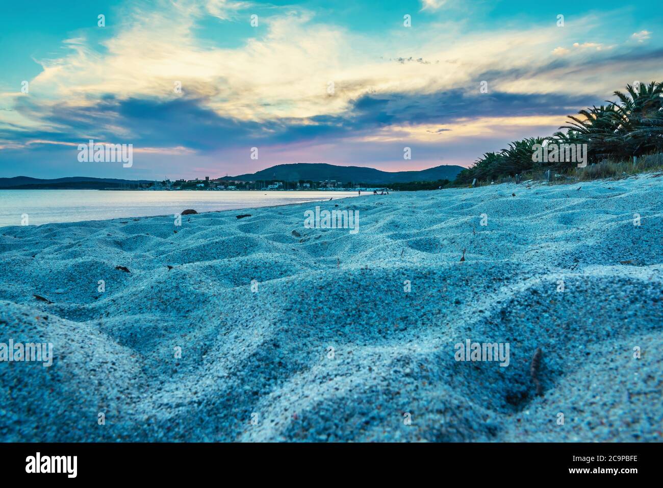 White sand in Maria Pia beach at sunset. Sardinia, Italy Stock Photo ...