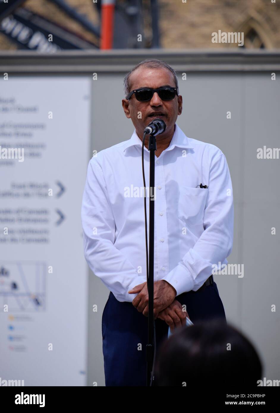 Federal Liberal MP Chandra Arya, speaking at outdoor event in from of ...
