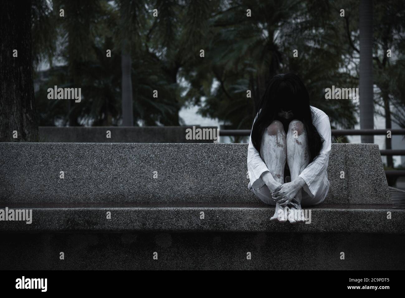 Woman ghost horror sitting her hug, halloween concept Stock Photo - Alamy