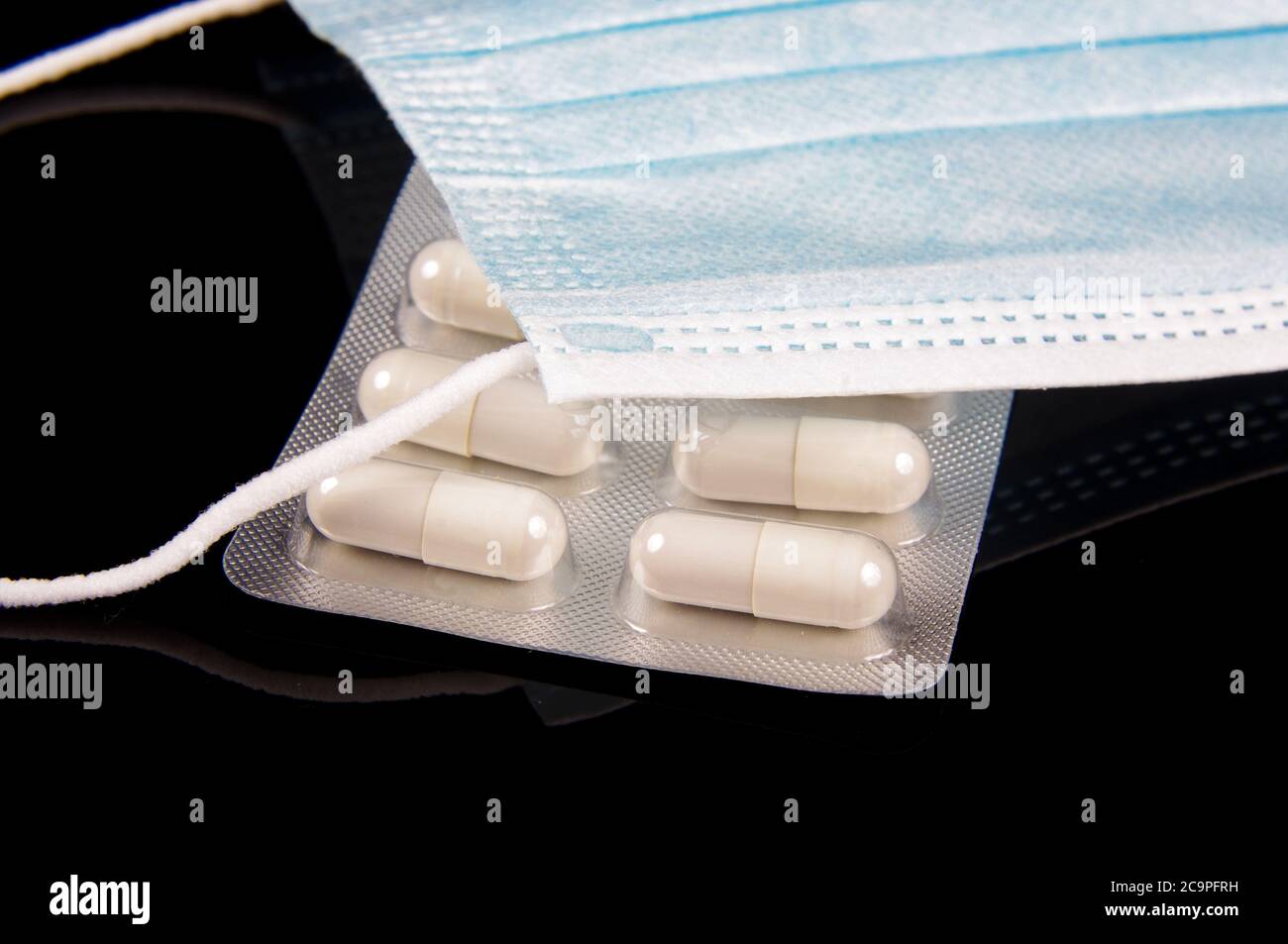 Medicine pills and virus protection face mask close up Stock Photo - Alamy