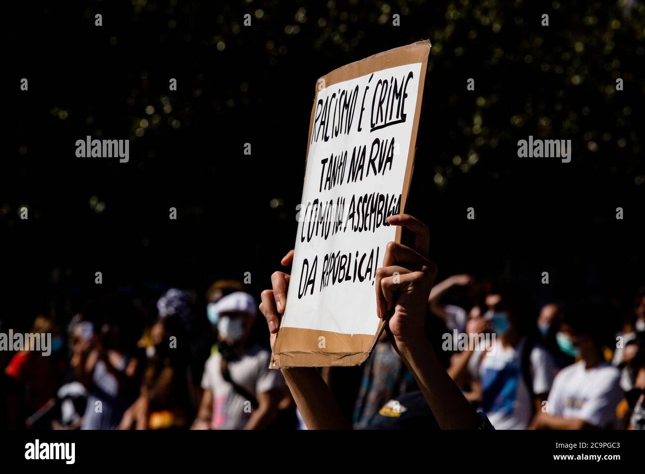 A protester holds a placard during the demonstration.Hundreds of Black ...