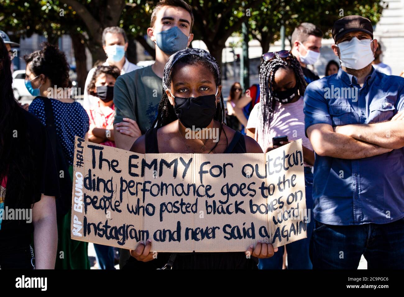 A protester holds a placard during the demonstration.Hundreds of Black ...