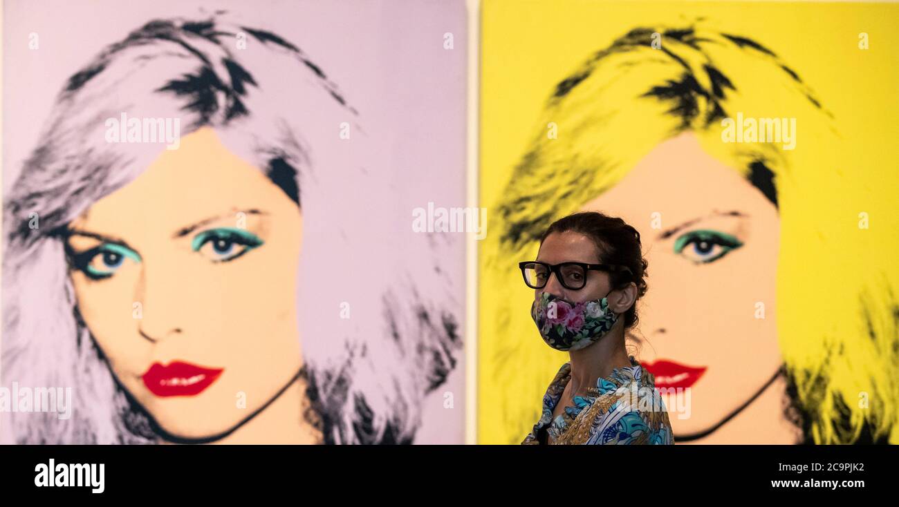 London, Britain. 1st Aug, 2020. A visitor wearing a face mask walks by ...