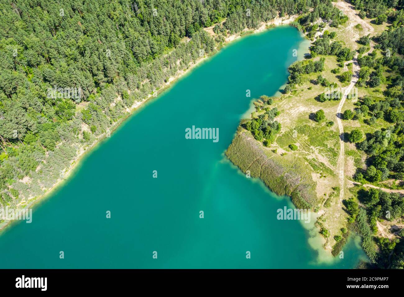 aerial top view on limestone quarry lake in forest during summer sunny ...