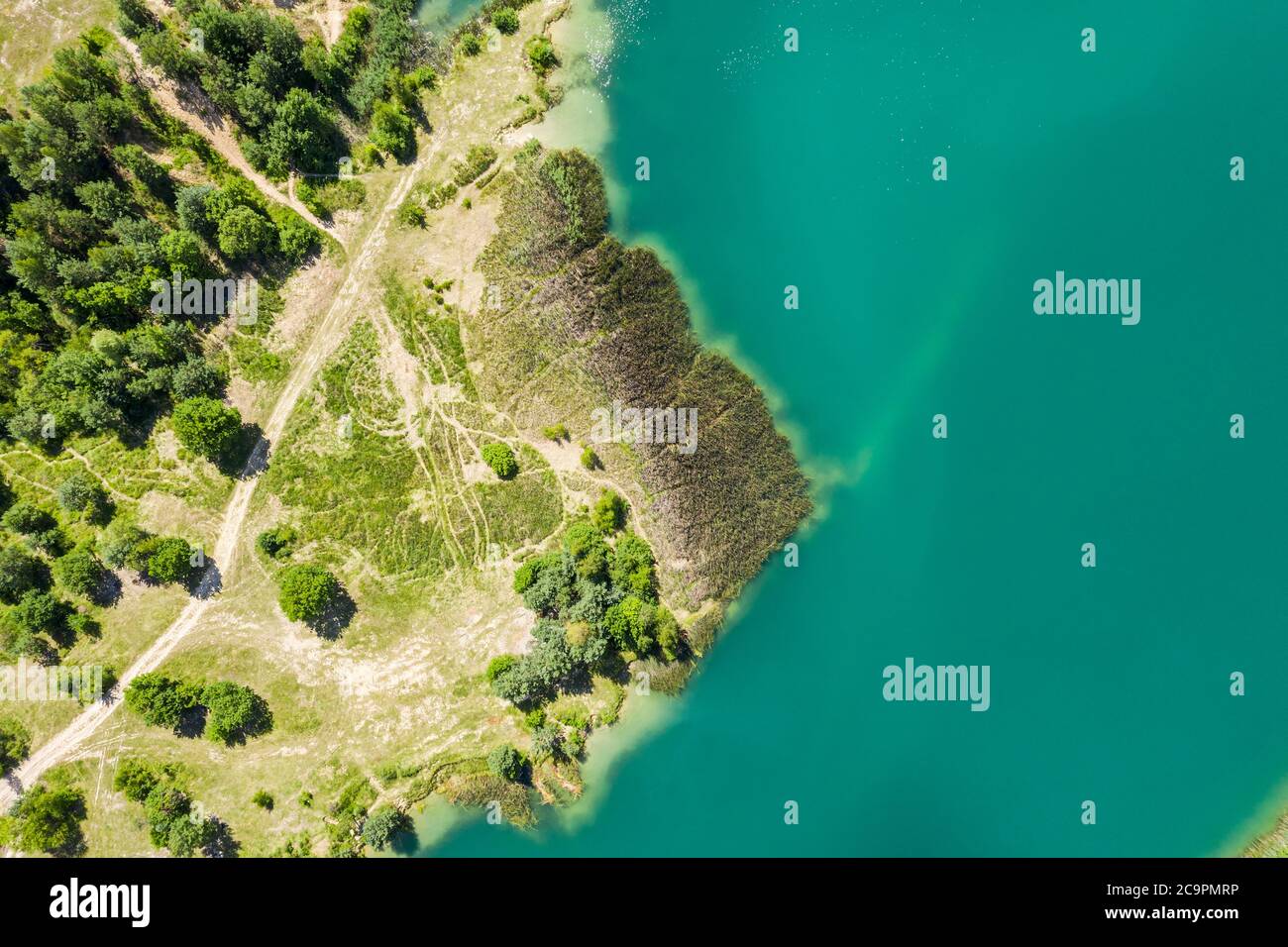 shore of the quarry lake with turquoise water. top view aerial photo ...