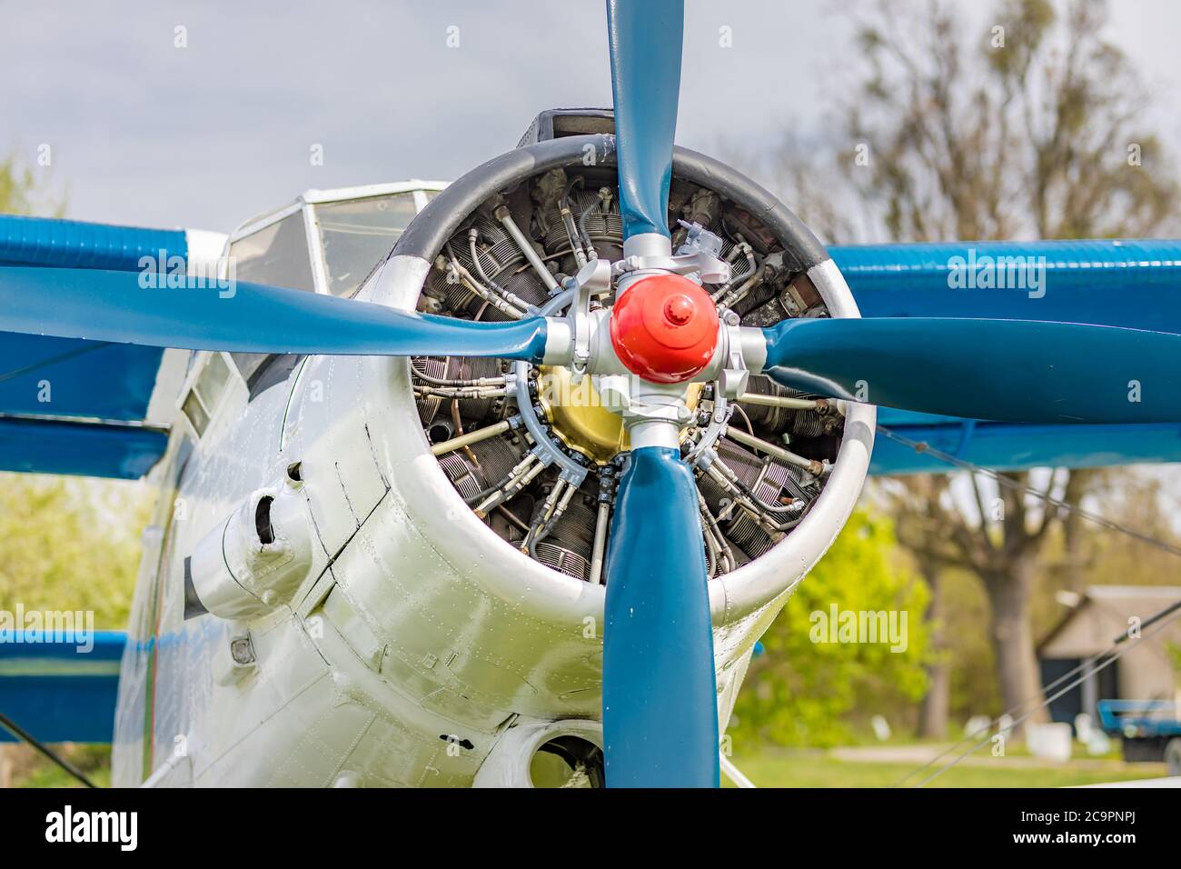 Old plane with propeller on beautiful bright sky background. Restored ...