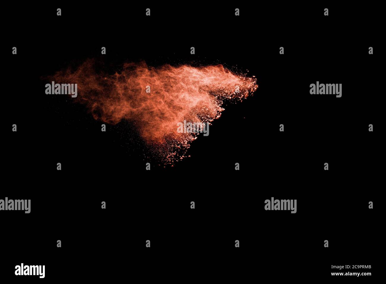 Orange color powder explosion on black background Stock Photo - Alamy