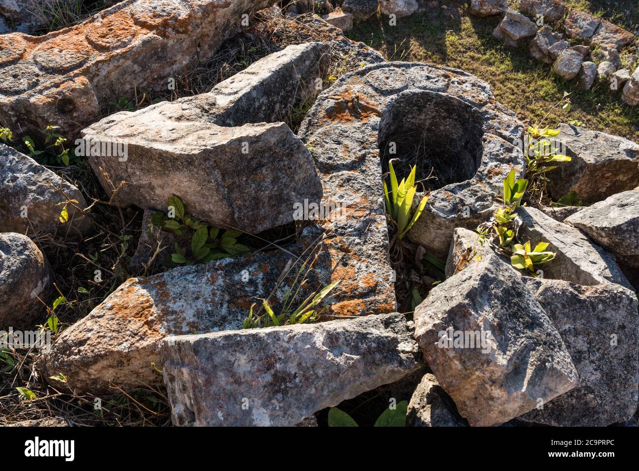 Carved building stones from Chaac masks in the ruins of the Codz Poop ...