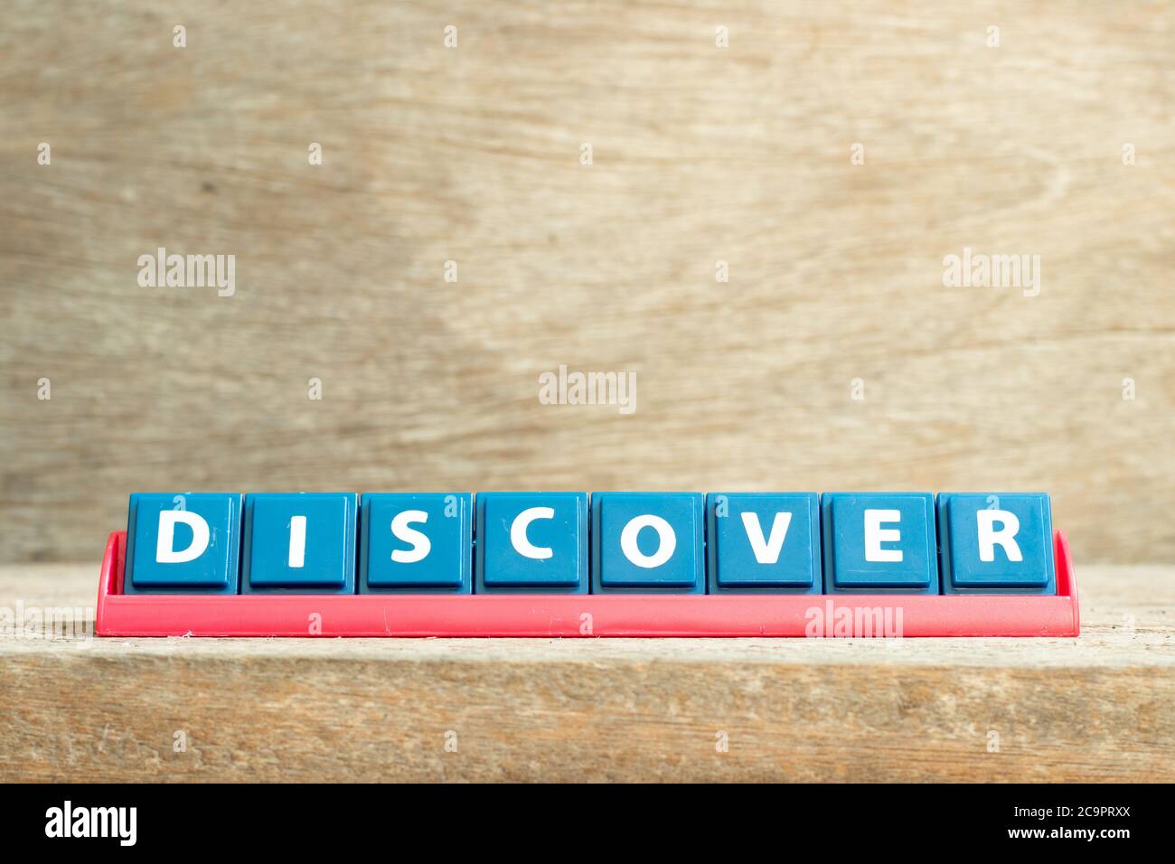 Tile letter on red rack in word discover on wood background Stock Photo ...